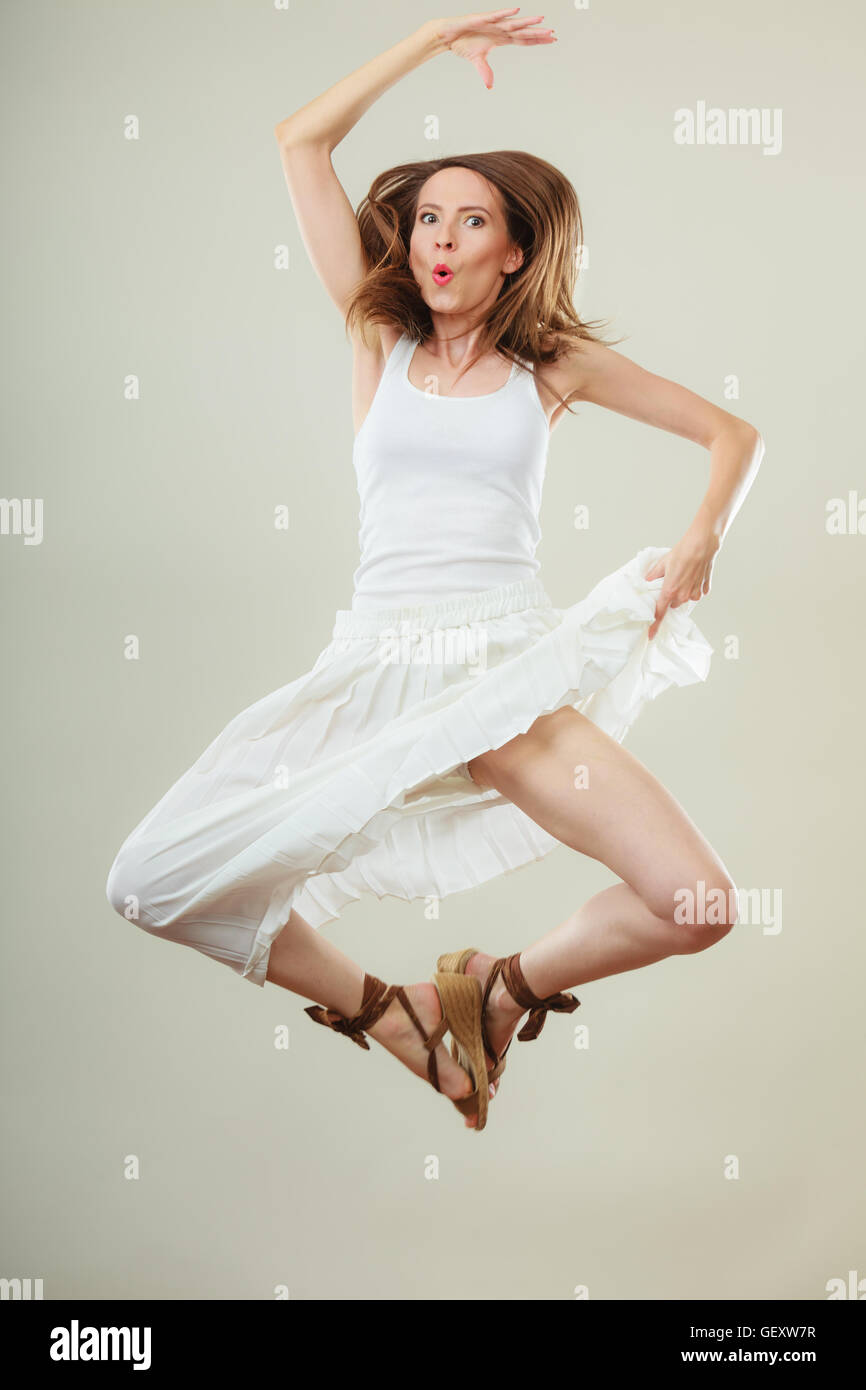 Woman wearing skirt jumping in hi-res stock photography and images - Alamy