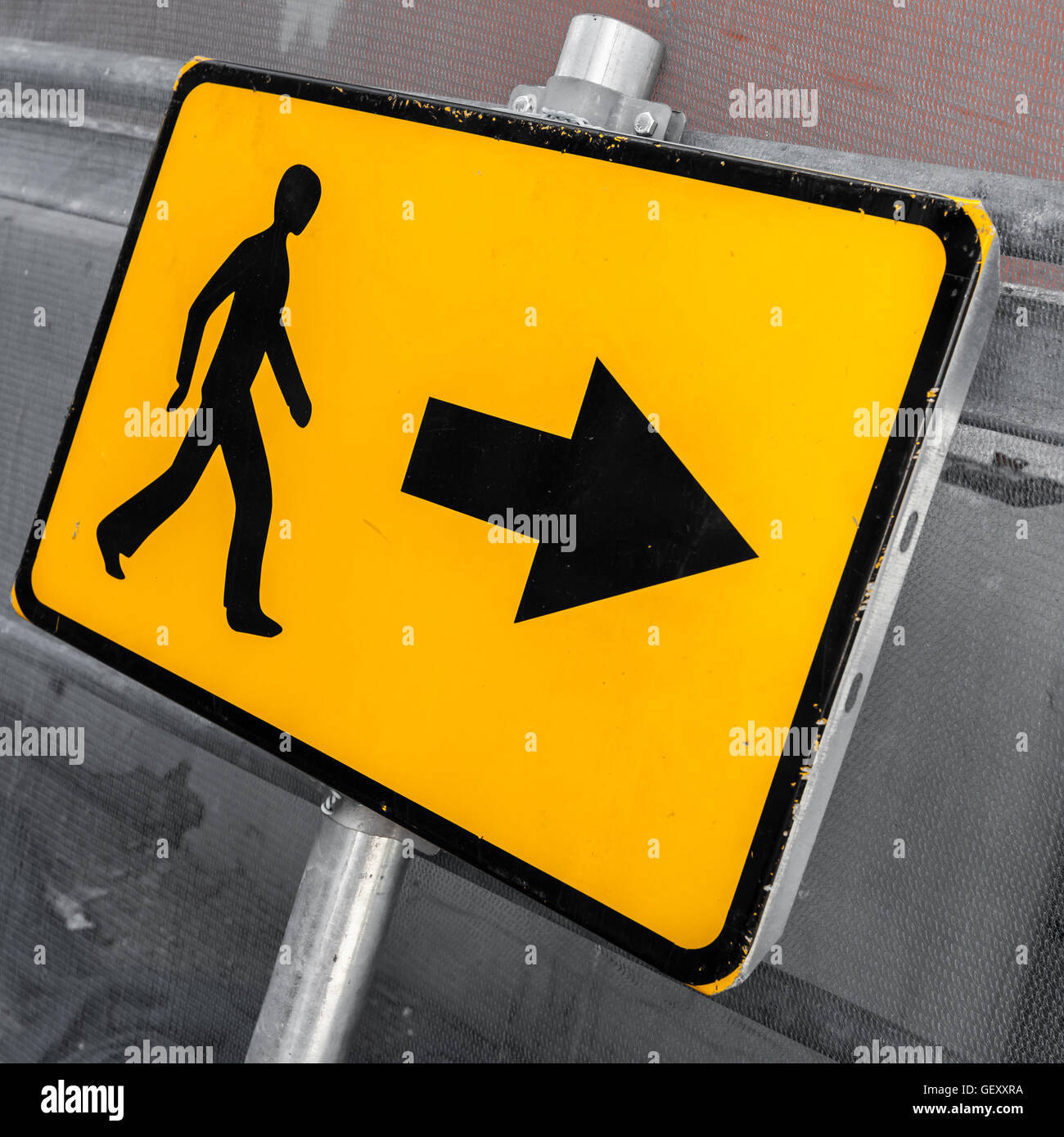 Pedestrians bypass direction. Yellow road sign close up photo Stock ...