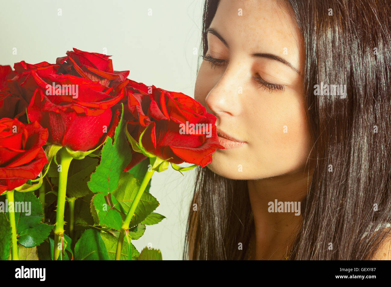 Portrait of a beautiful young girl with a bouquet of roses Stock Photo ...