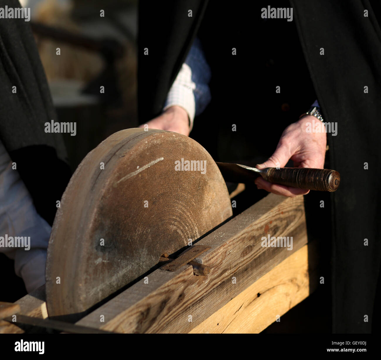 Elder knife sharpener sharpens his knife Stock Photo - Alamy