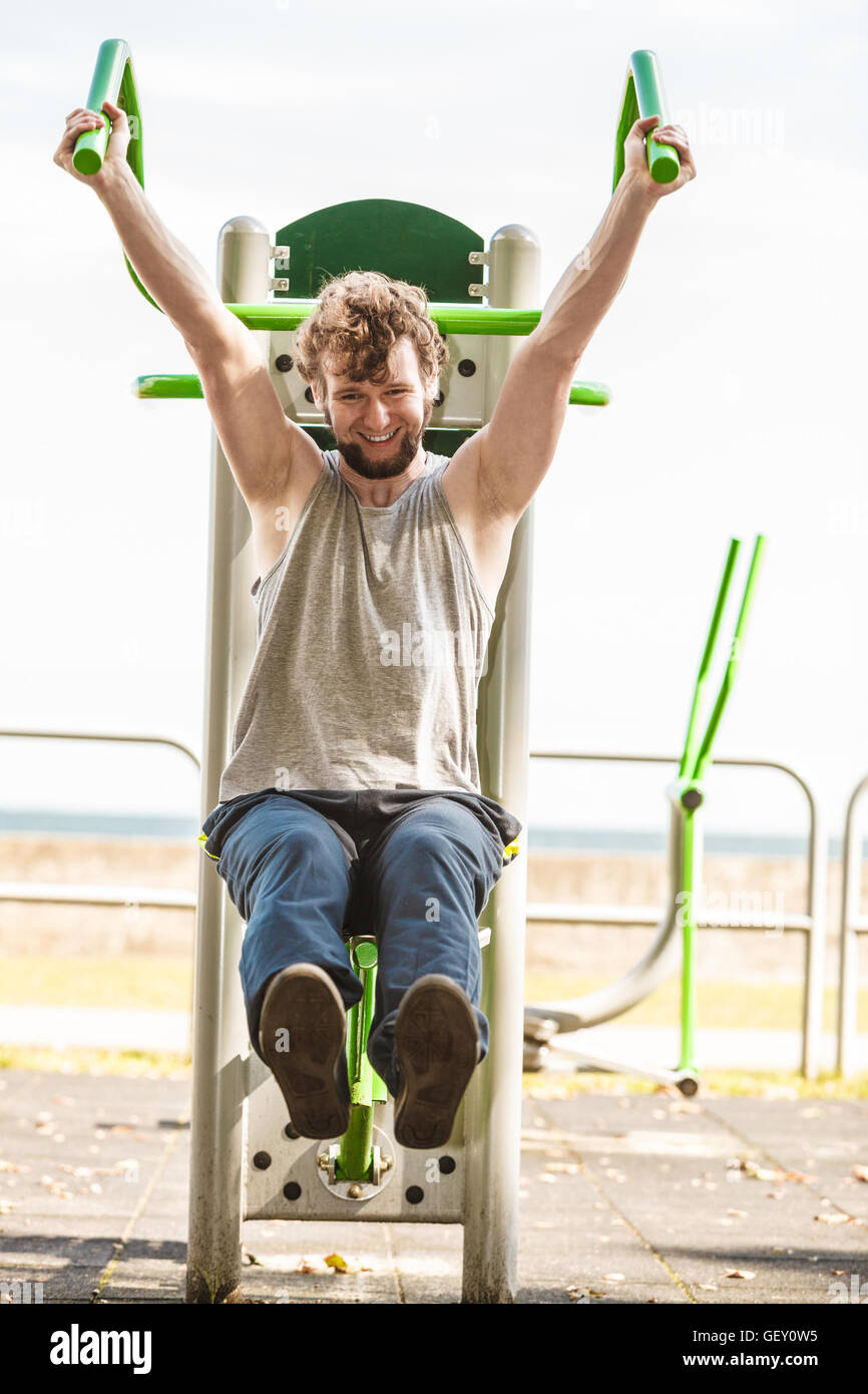Active young man exercising on chest press machine. Muscular strong guy ...