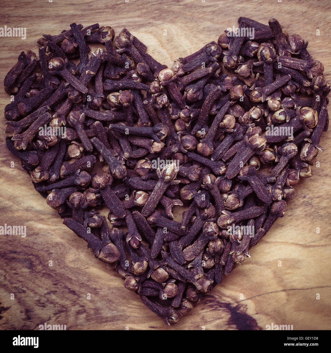 Heart form made from spice cloves on wooden background Stock Photo - Alamy