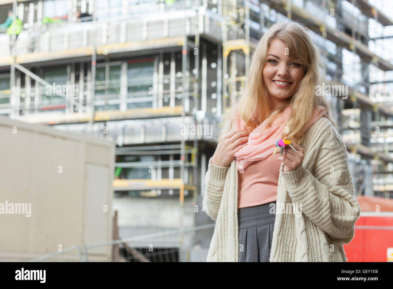Real estate concept - young woman on front of new big modern house ...