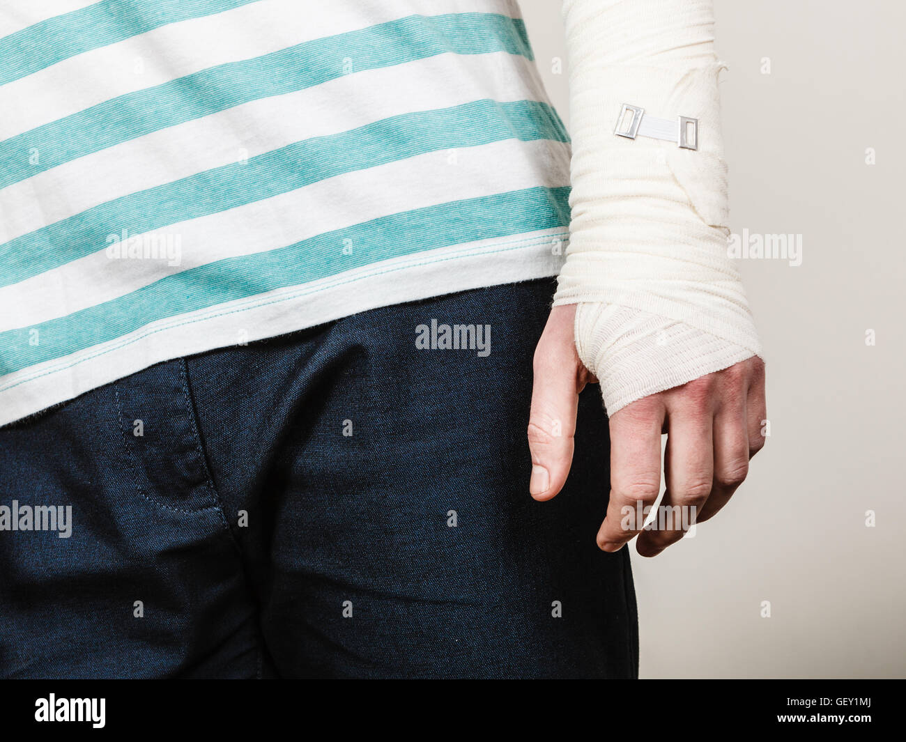 Fractures and dislocations concept. Part body male with hand in bandage ...