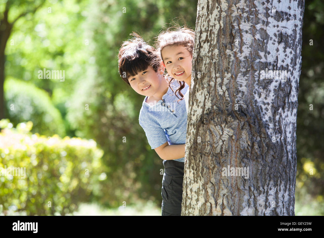 Happy Chinese children playing in woods Stock Photo - Alamy