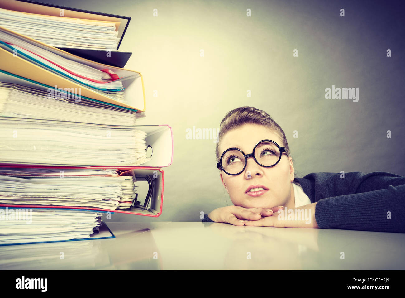 A lot of work and overwork concept. Terrified young businesswoman ...