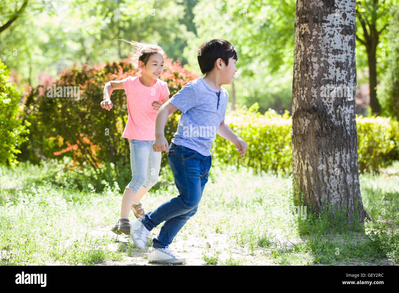 Happy Chinese children playing in woods Stock Photo - Alamy