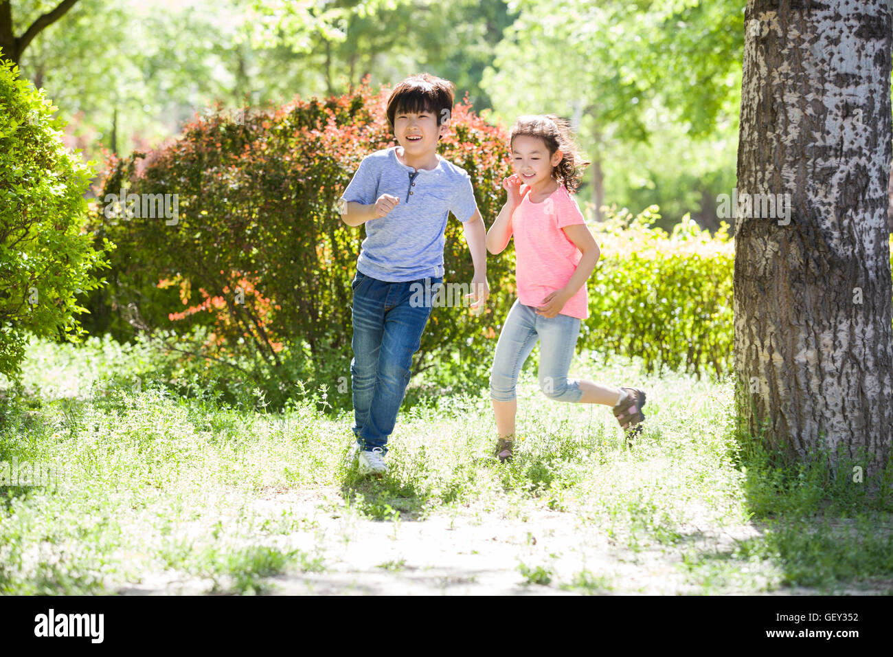 Happy Chinese children playing in woods Stock Photo - Alamy