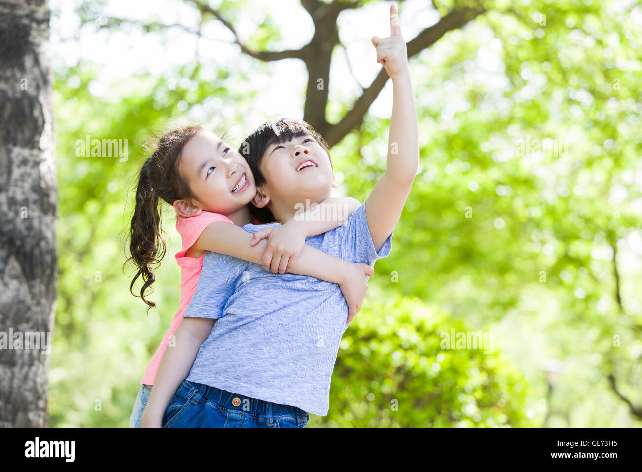 Happy Chinese children playing in woods Stock Photo - Alamy