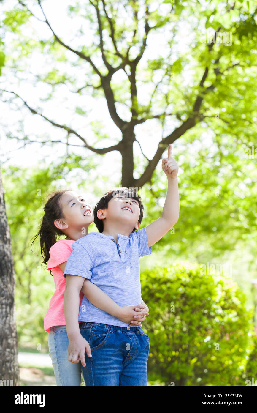 Happy Chinese children playing in woods Stock Photo - Alamy