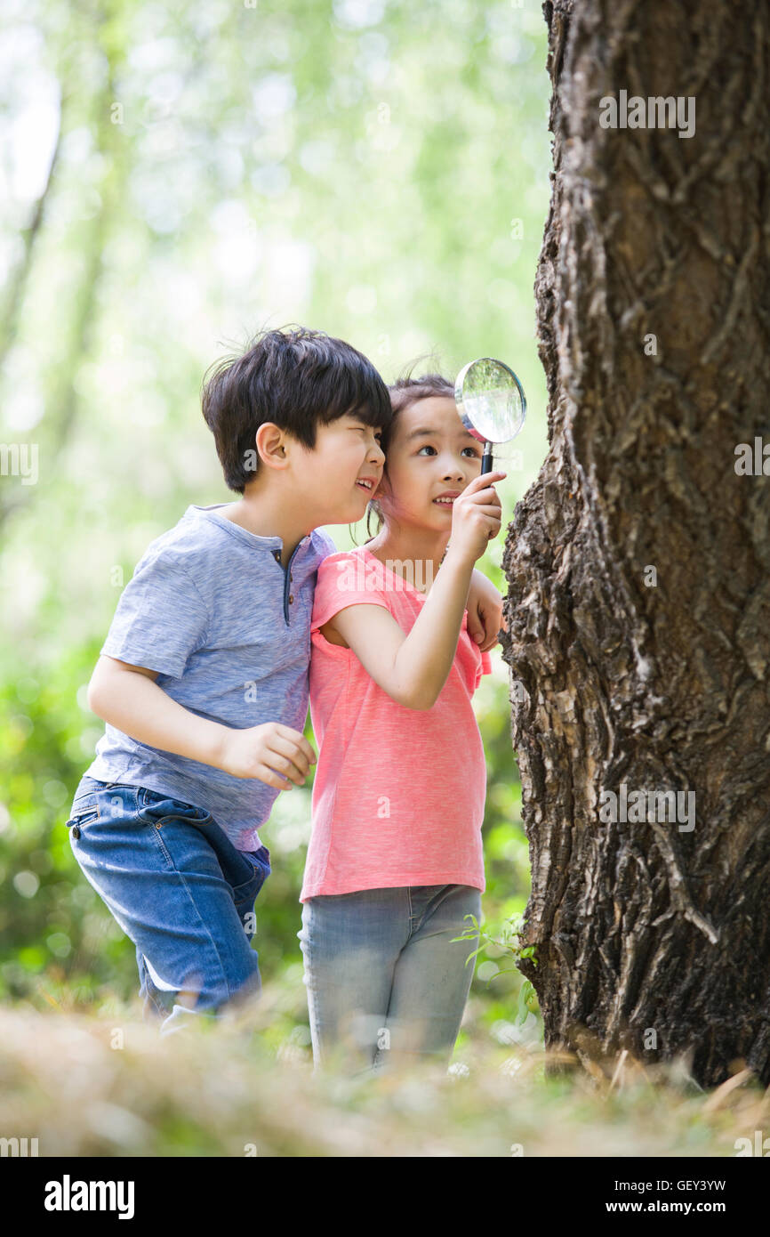 Happy Chinese children playing in woods Stock Photo - Alamy