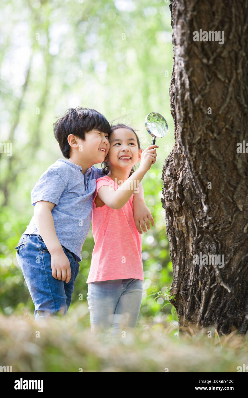 Happy Chinese children playing in woods Stock Photo - Alamy