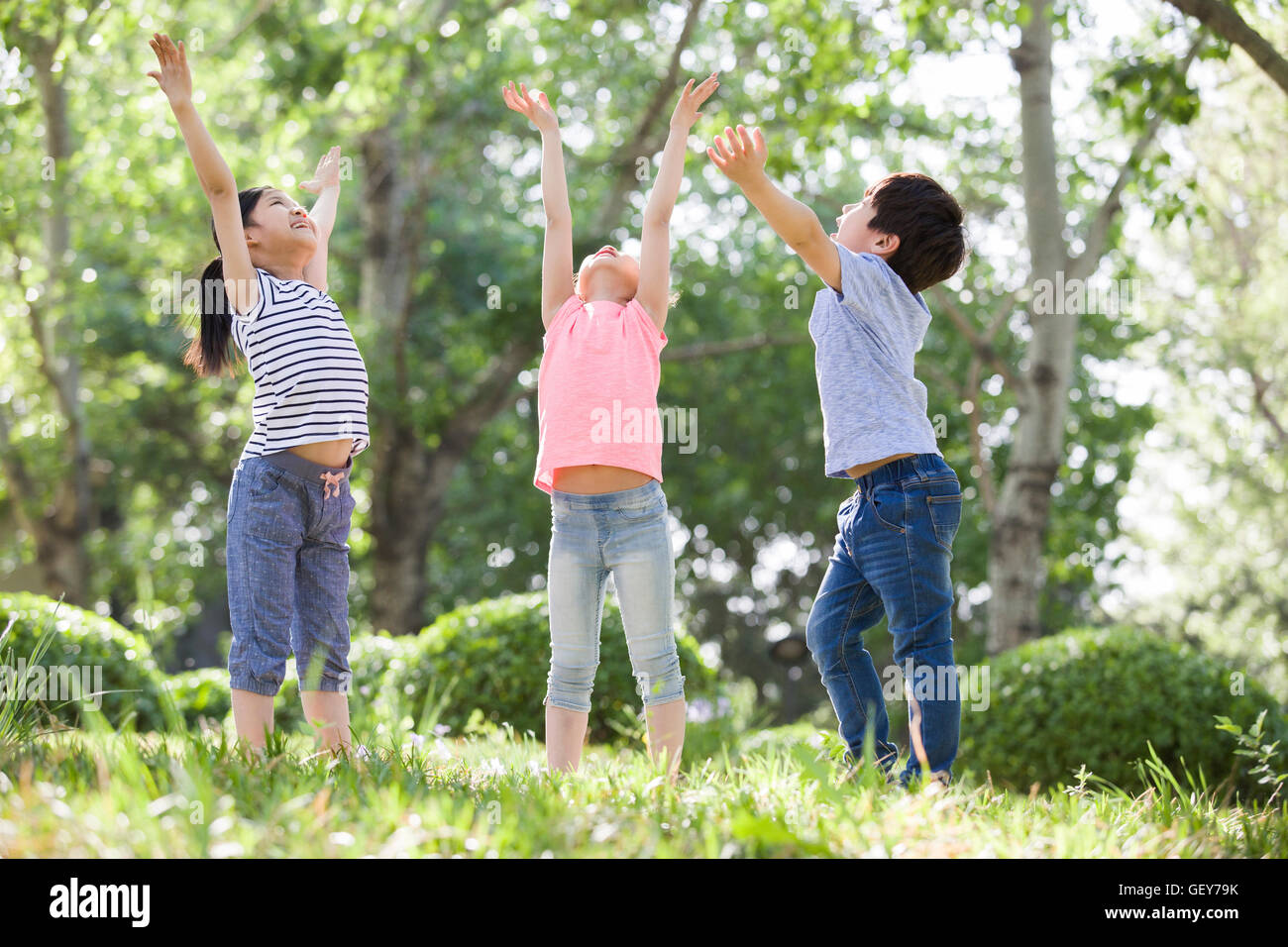 Happy Chinese children playing in woods Stock Photo - Alamy