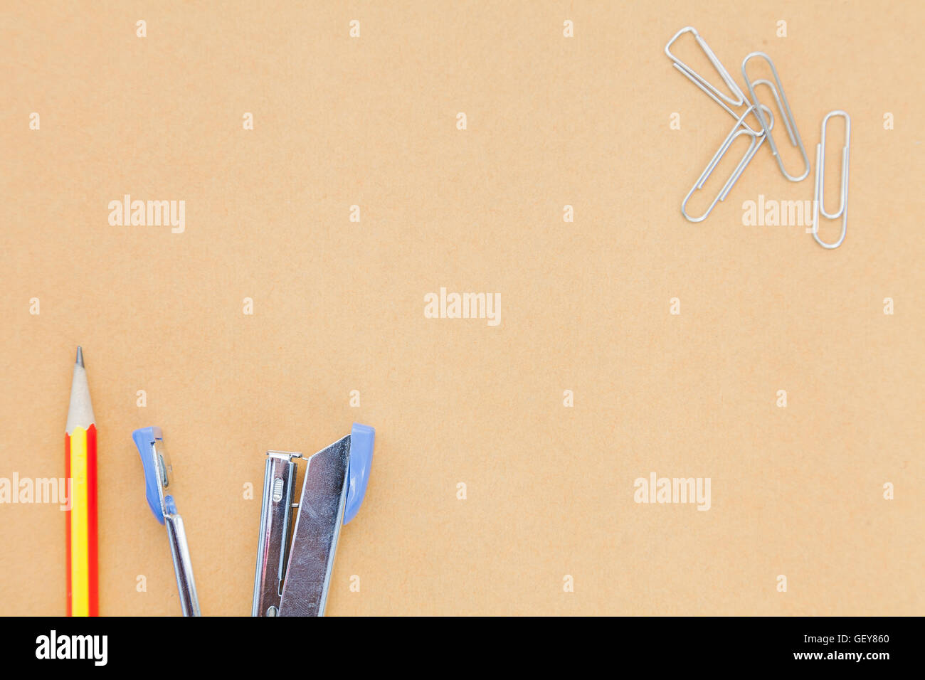 pencil staple and clip placed on brown paper Stock Photo - Alamy