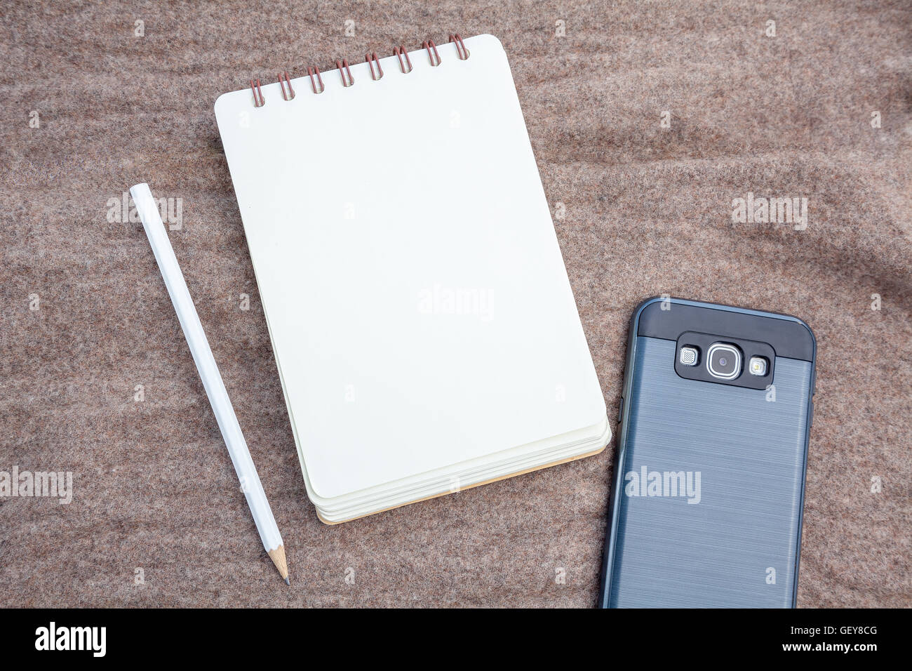 pencil, notebook and mobile phone Stock Photo - Alamy