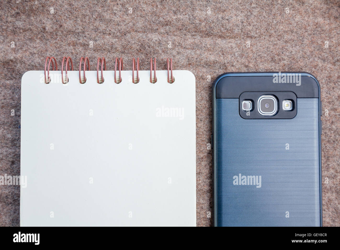 notebook page and smartphone on brown fabric Stock Photo - Alamy