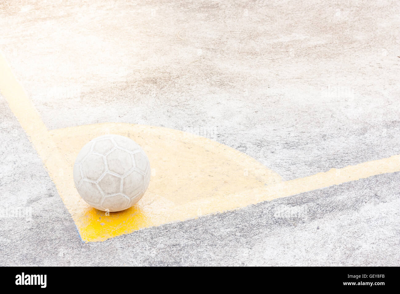 it's a ball of soccer or football place on yellow corner, ground is ...