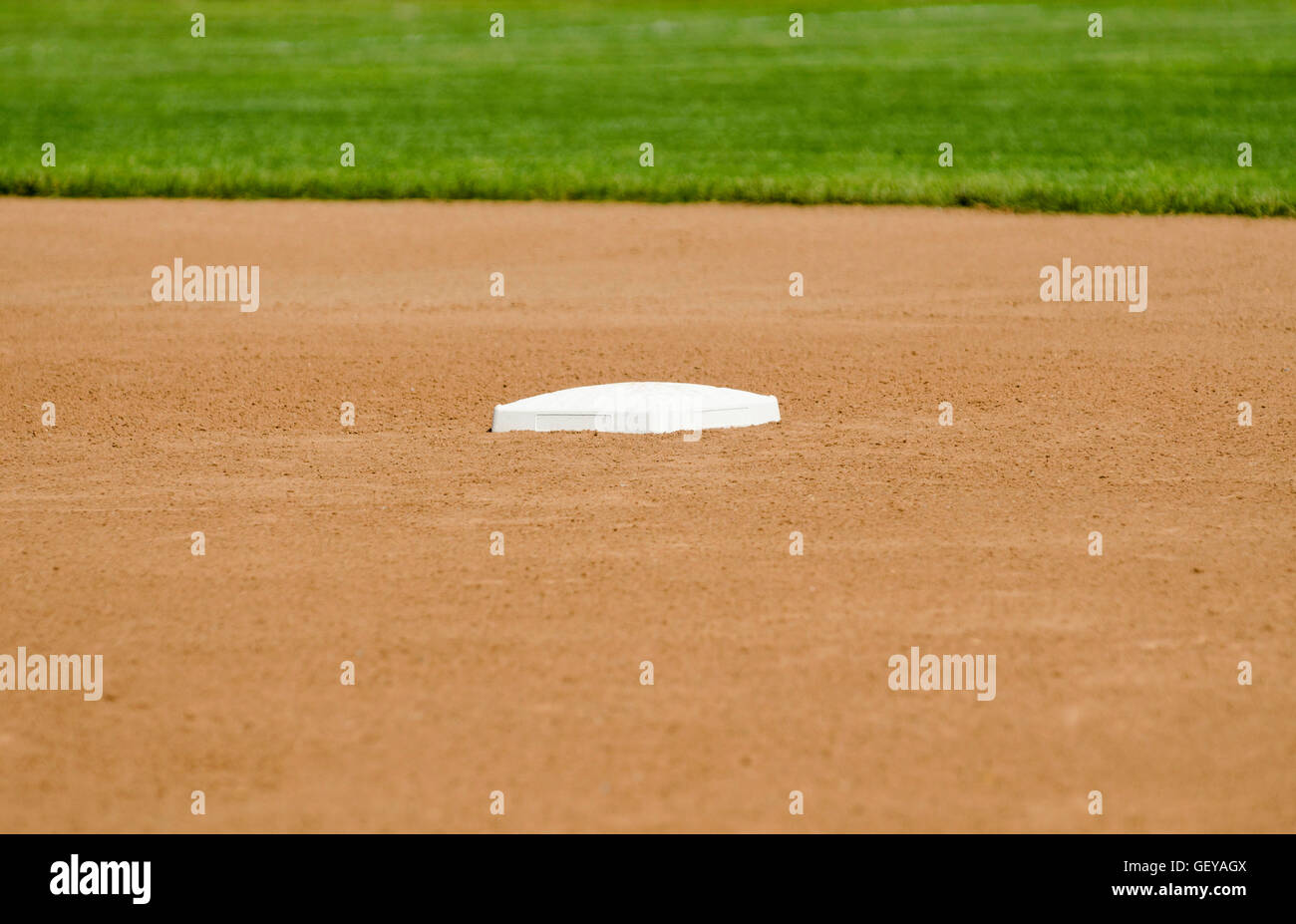 White second base on baseball field Stock Photo - Alamy
