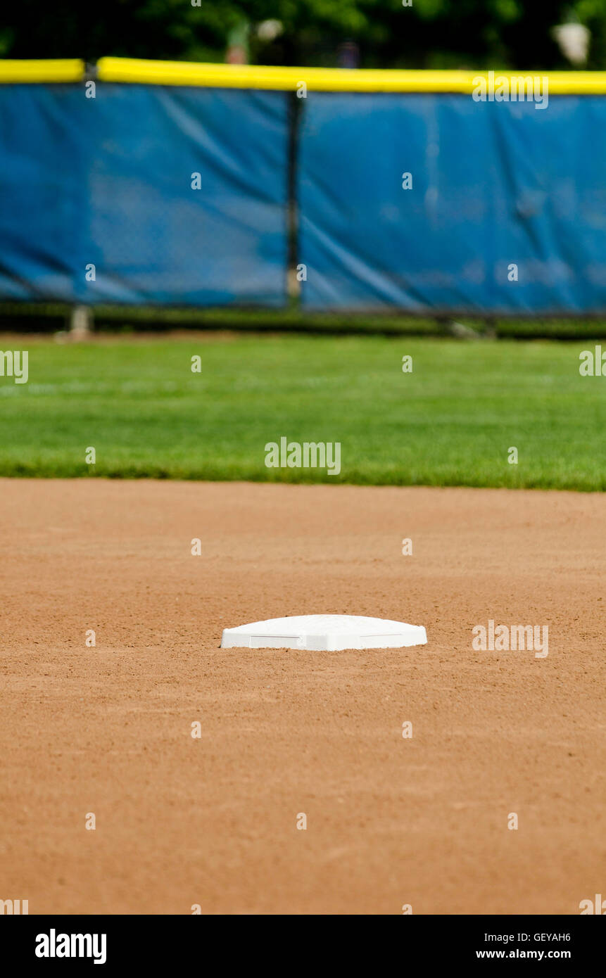 White second base on baseball field Stock Photo - Alamy
