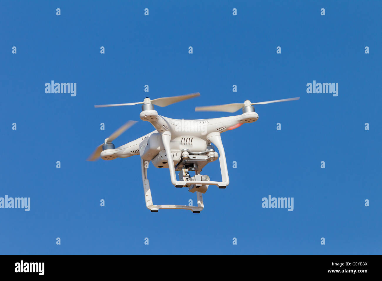 Drone video camera flying remote controlled blue sky Stock Photo - Alamy