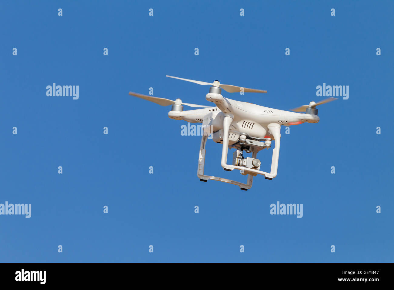 Drone video camera flying remote controlled blue sky Stock Photo - Alamy