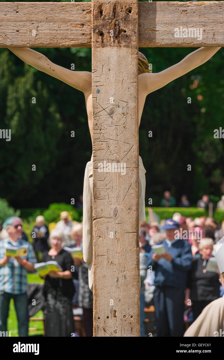 A congregation sings a hymn before a life-size model of the crucifixion ...