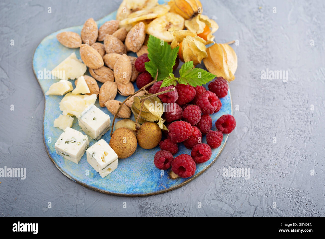 Fruit and nuts cheese board Stock Photo - Alamy