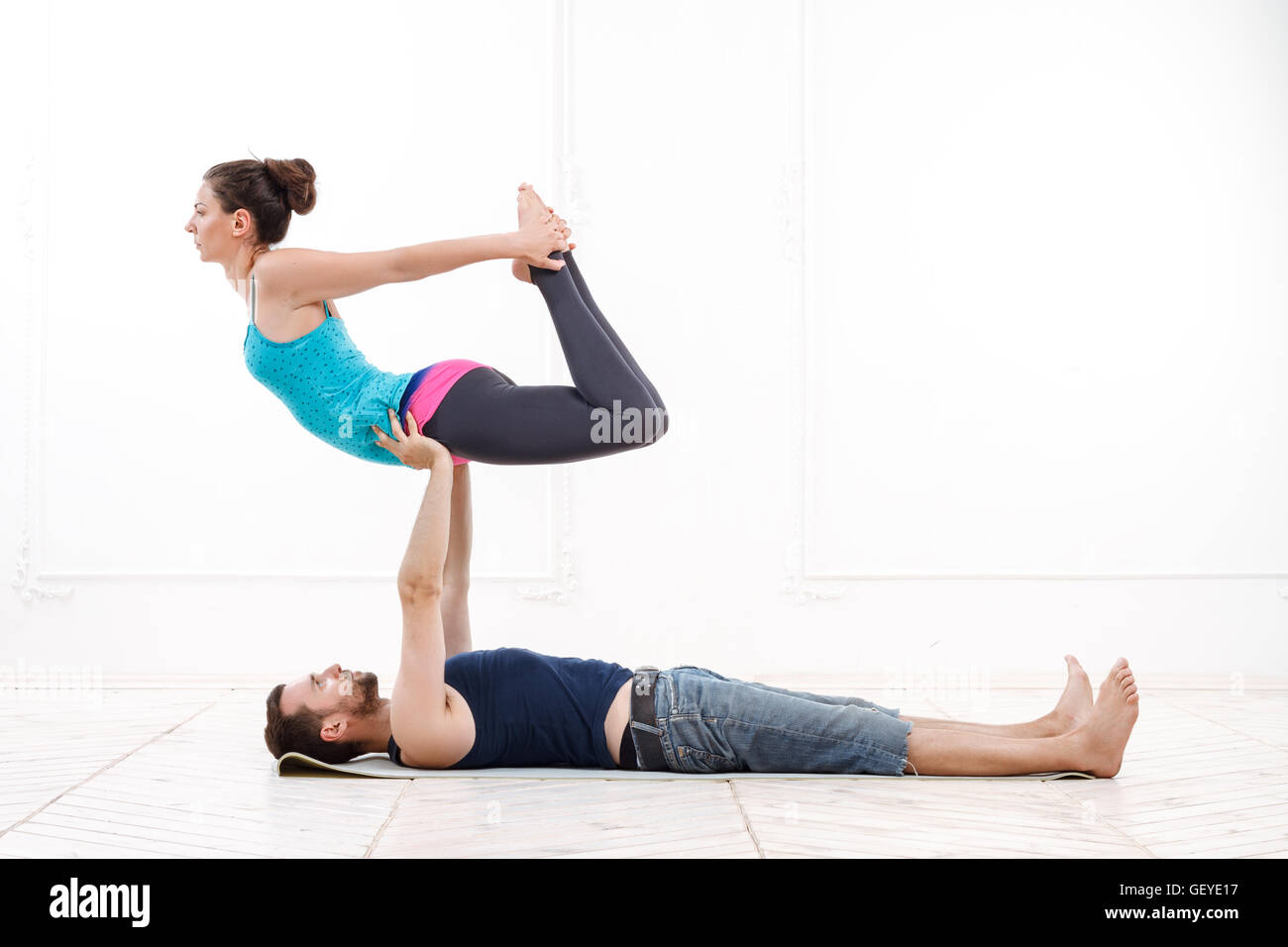 Beautiful Young Couple Practicing Acro-Yoga Stock Photo - Alamy