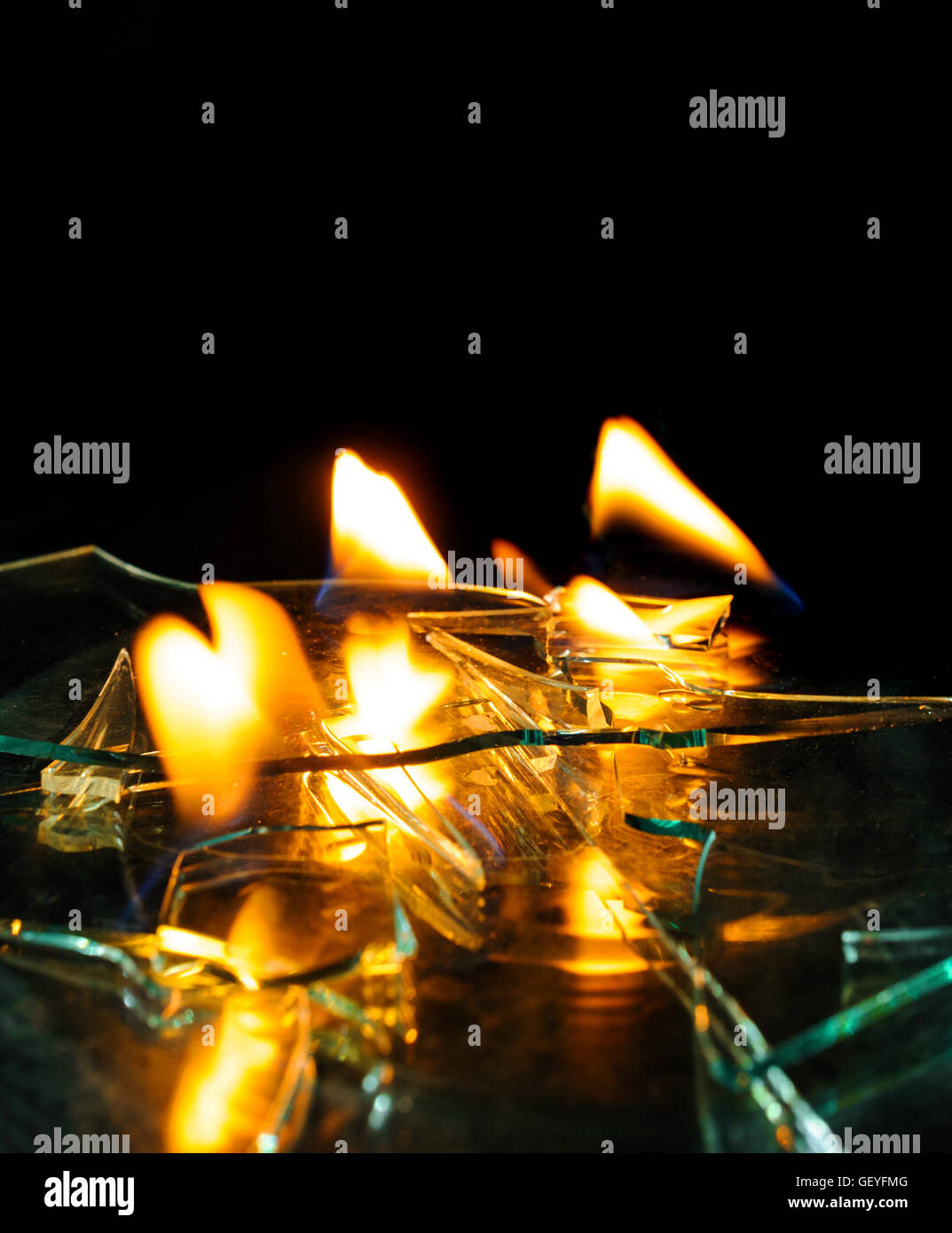 fire burning on cracked glass over black background Stock Photo - Alamy