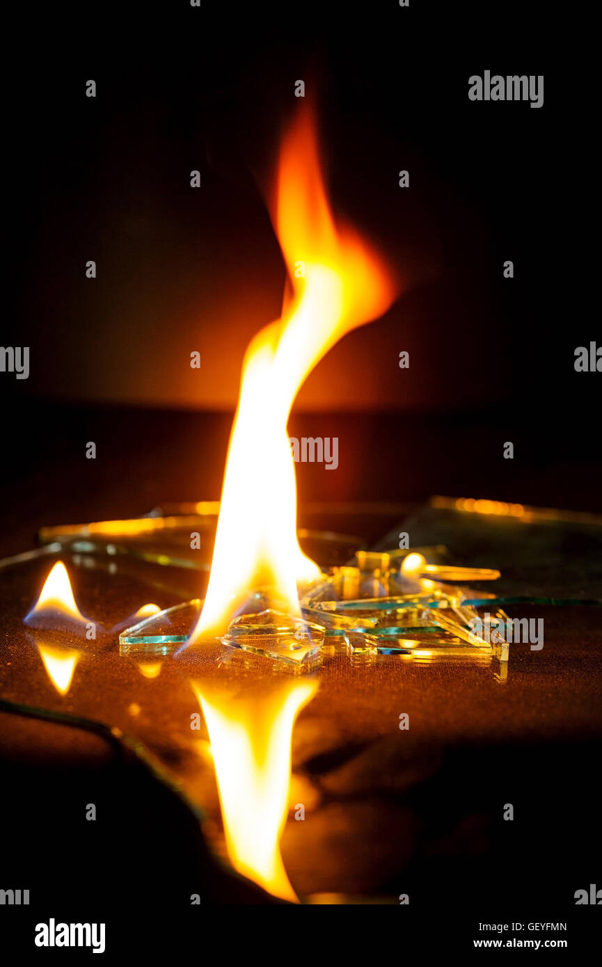 fire burning on cracked glass over black background Stock Photo - Alamy