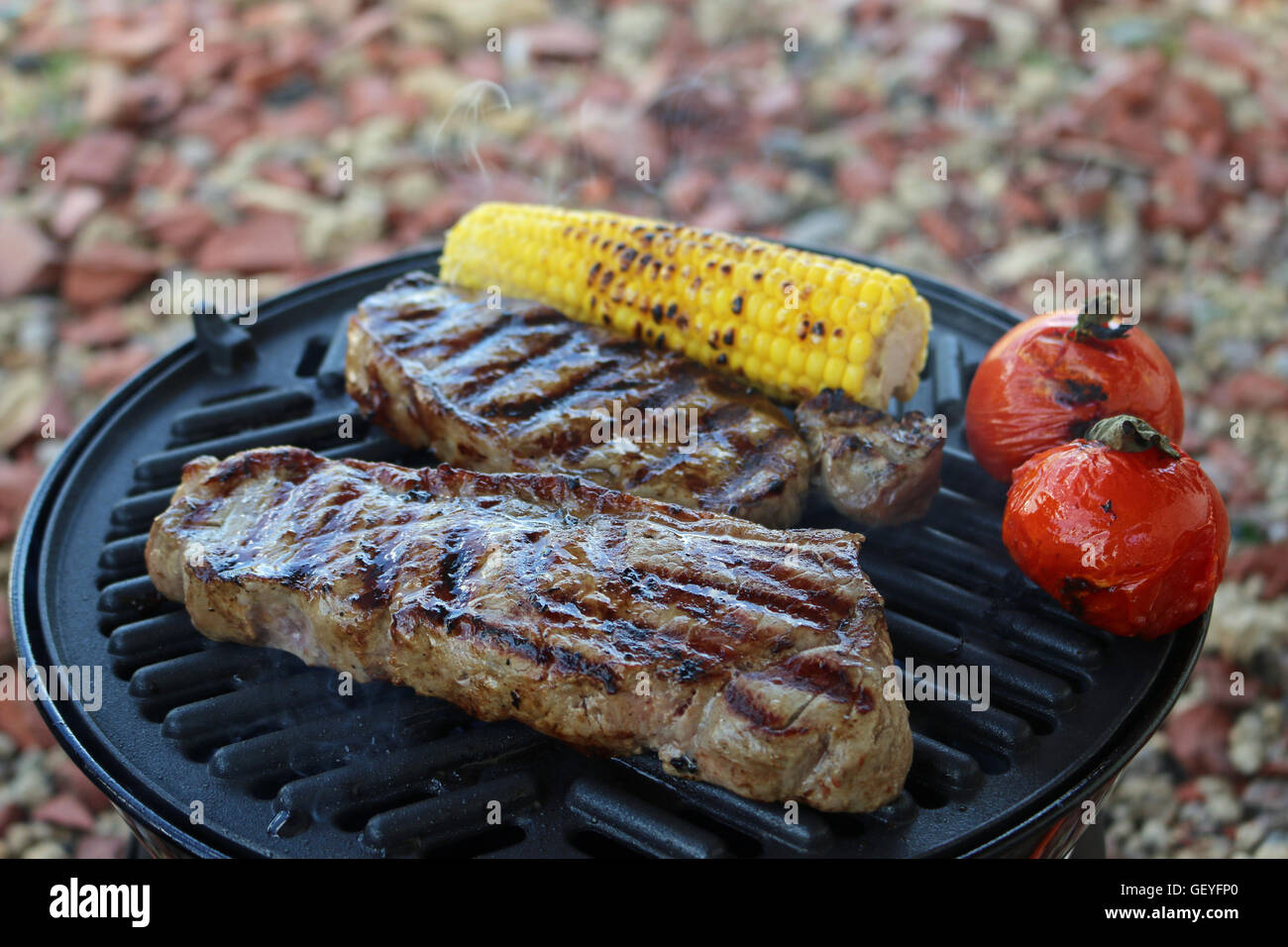 Two steaks on a barbeque Stock Photo - Alamy