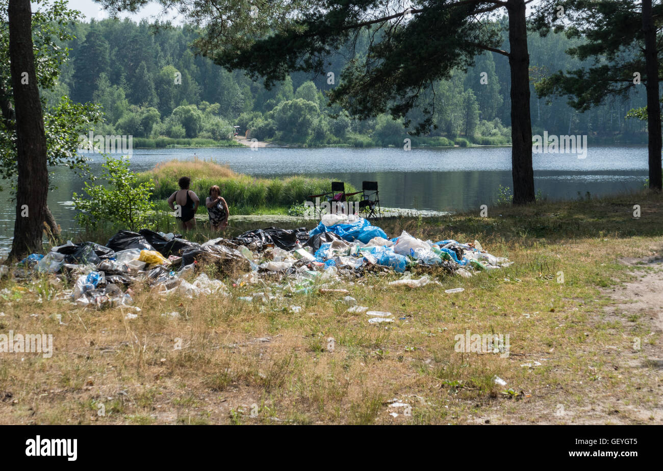 Garbage waste in the woods by the lake Stock Photo - Alamy