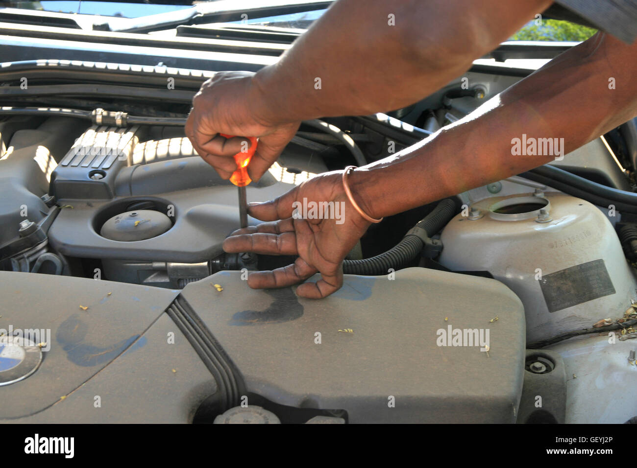 Black mechanic working on car hi-res stock photography and images - Alamy