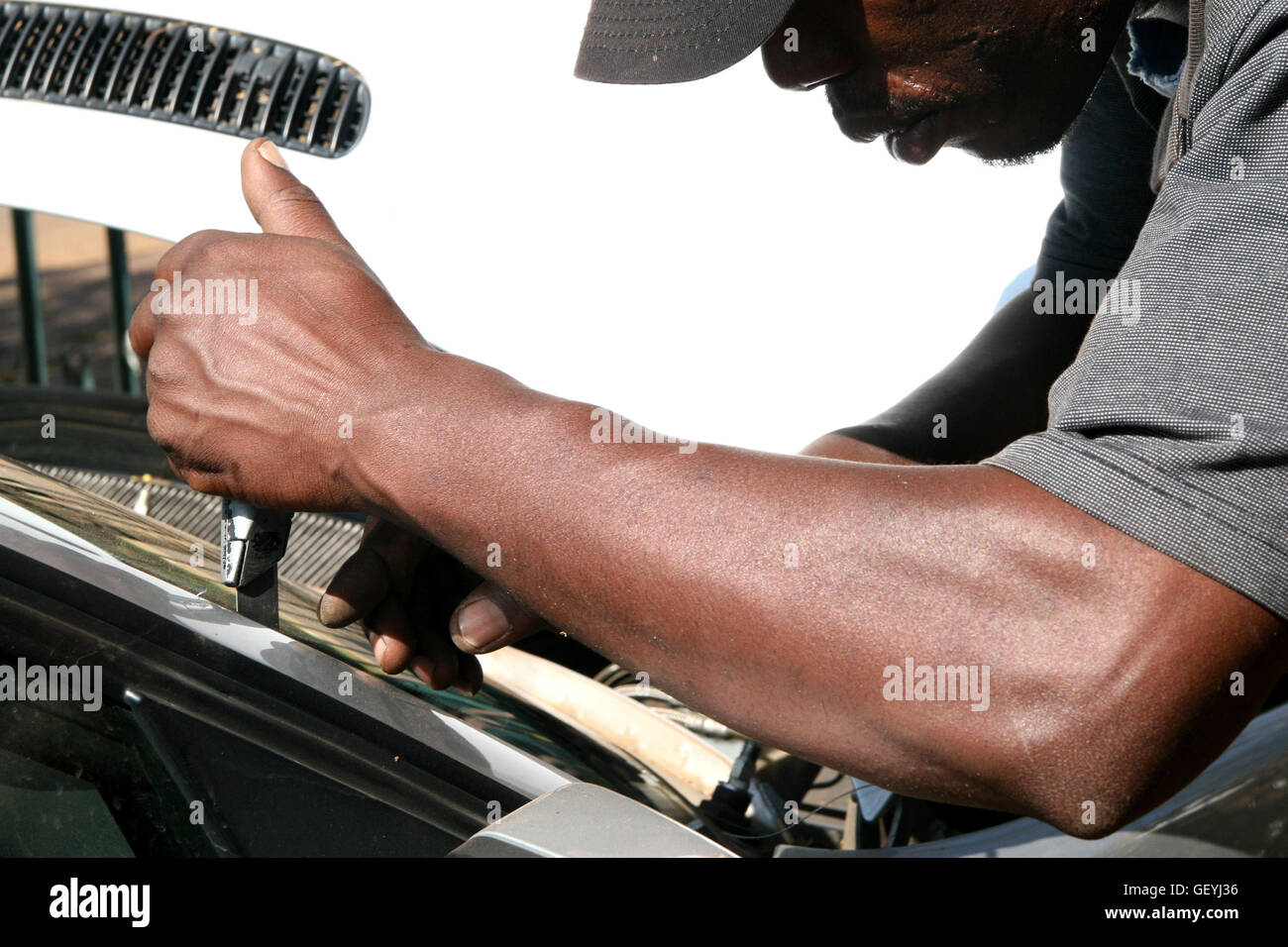 Man fixing the windscreen of a car, South Africa Stock Photo - Alamy