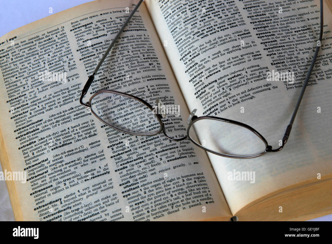 Old book, dictionary with spectacles lying on open pages, close-up ...