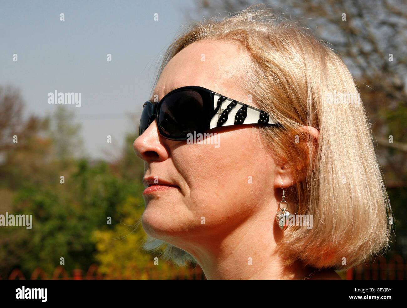 Side view of a lady with blonde hair, close-up Stock Photo - Alamy