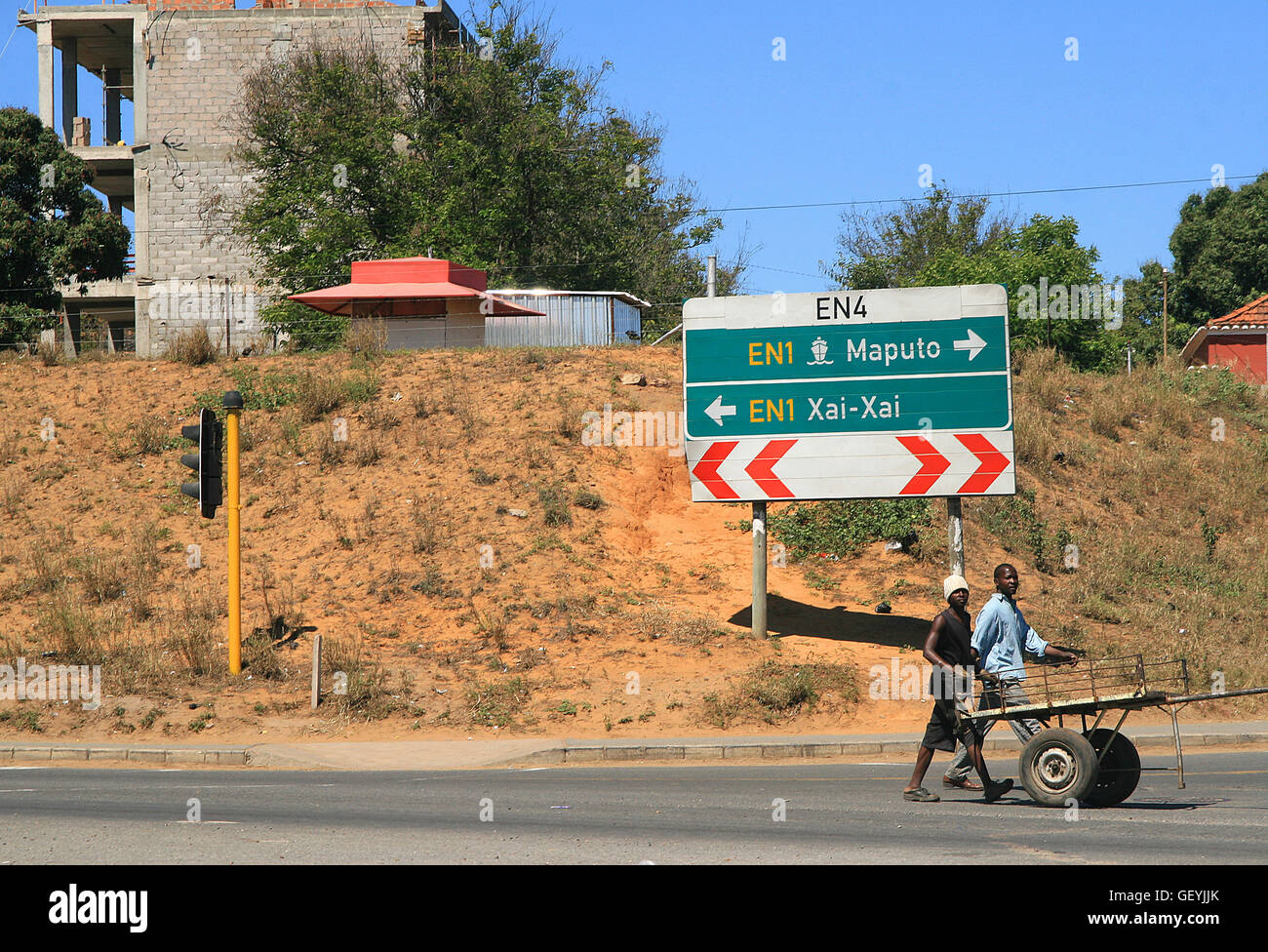 Two men pushing trailer on road hi-res stock photography and images - Alamy