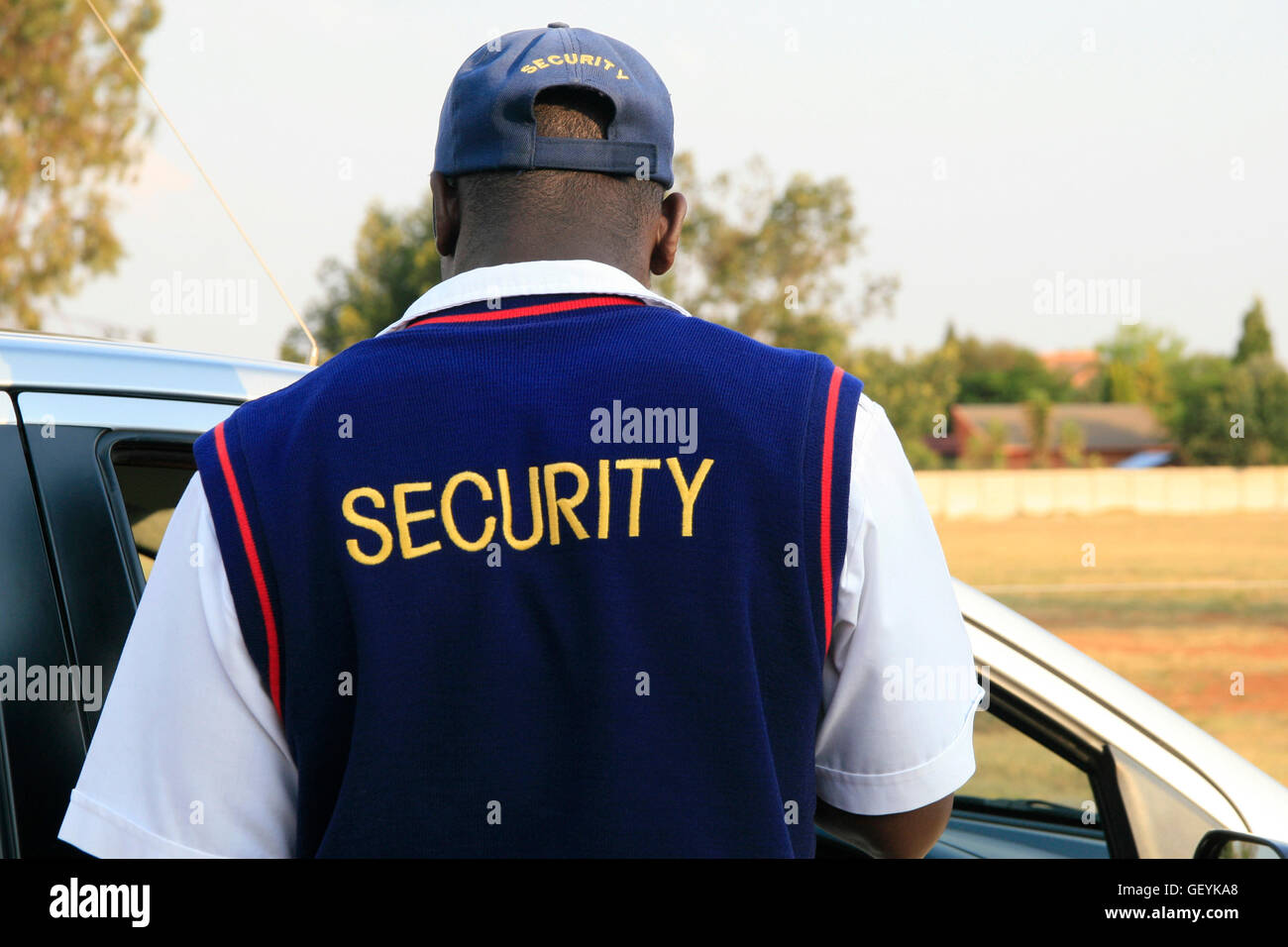 Back of security guard inspecting car, near The Villa Mall, Moreleta ...
