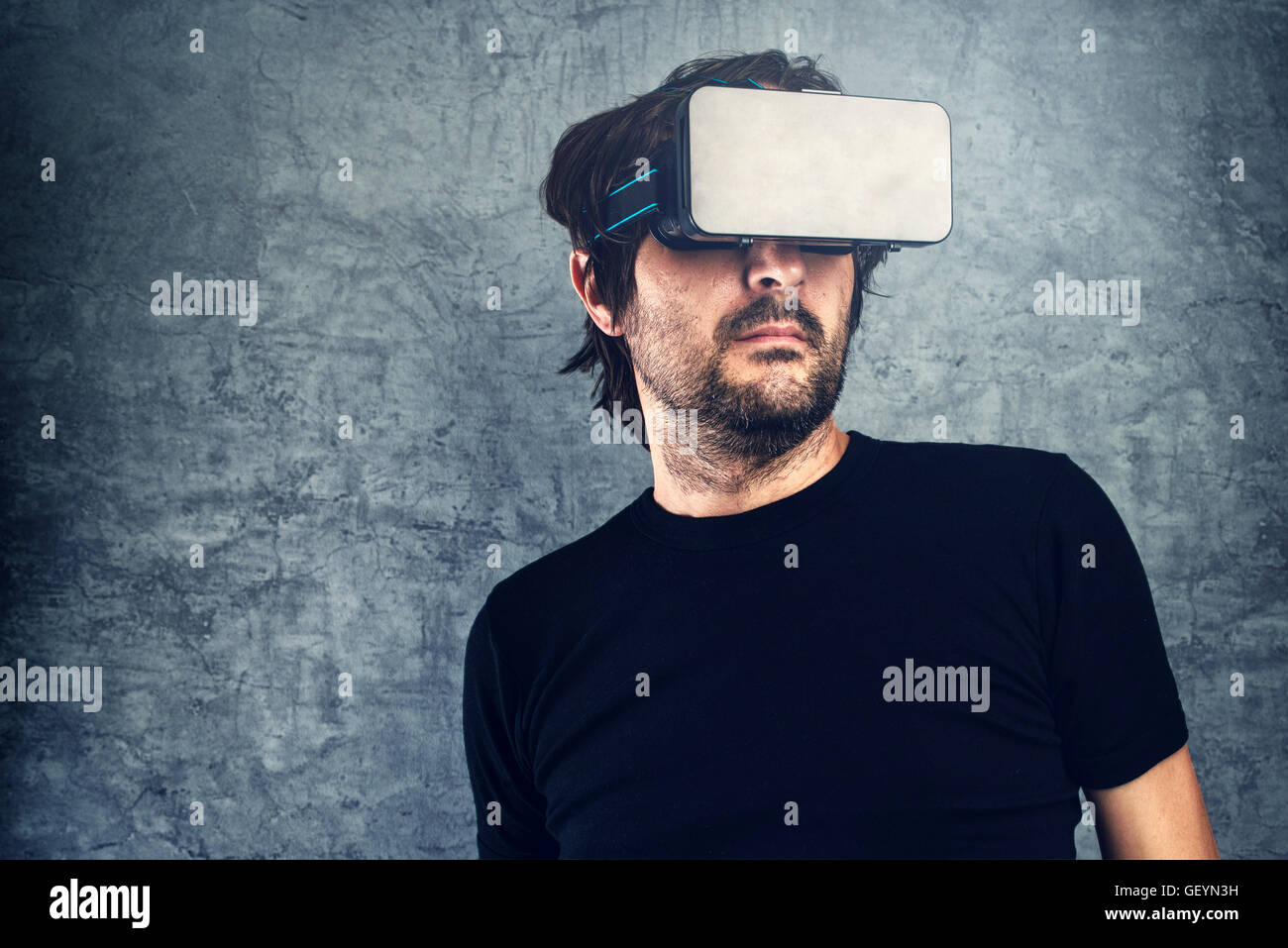 Adult Man wearing virtual reality goggles for 3d VR multimedia content ...