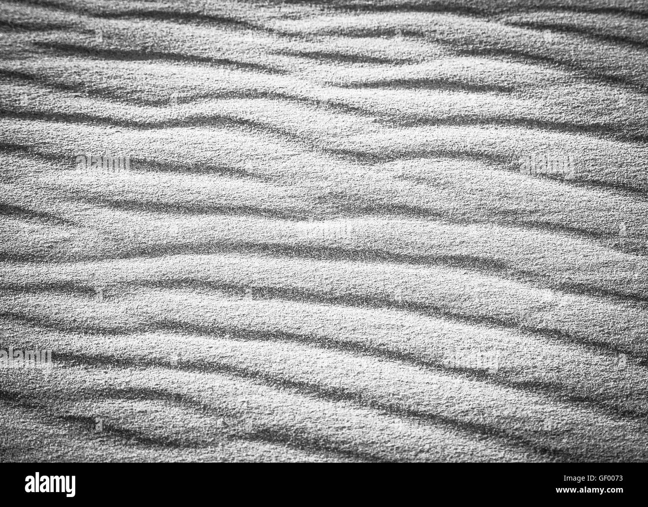 Black and white highly contrasted pattern in the beach sand on the sand ...