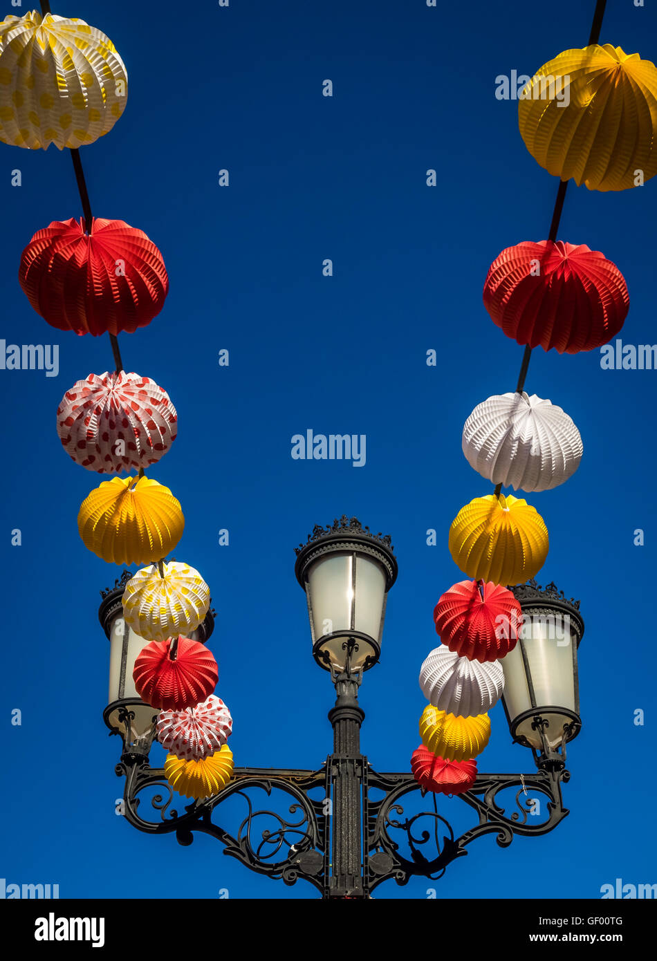Colorful decorations hanging between traditional old buildings during ...