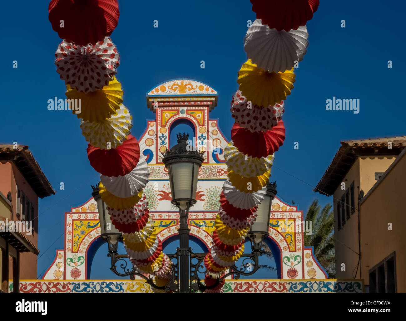 Colorful decorations hanging between traditional old buildings during ...