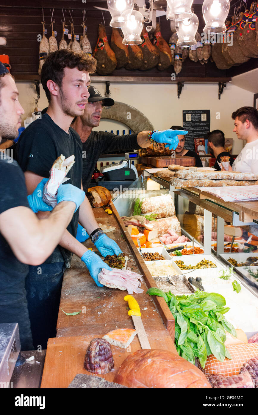 Staff hard at work serving the large queue of customers at All'Antico ...