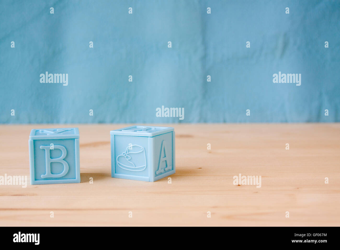 Blue Baby Blocks on a Blue and Wooden Background Stock Photo - Alamy