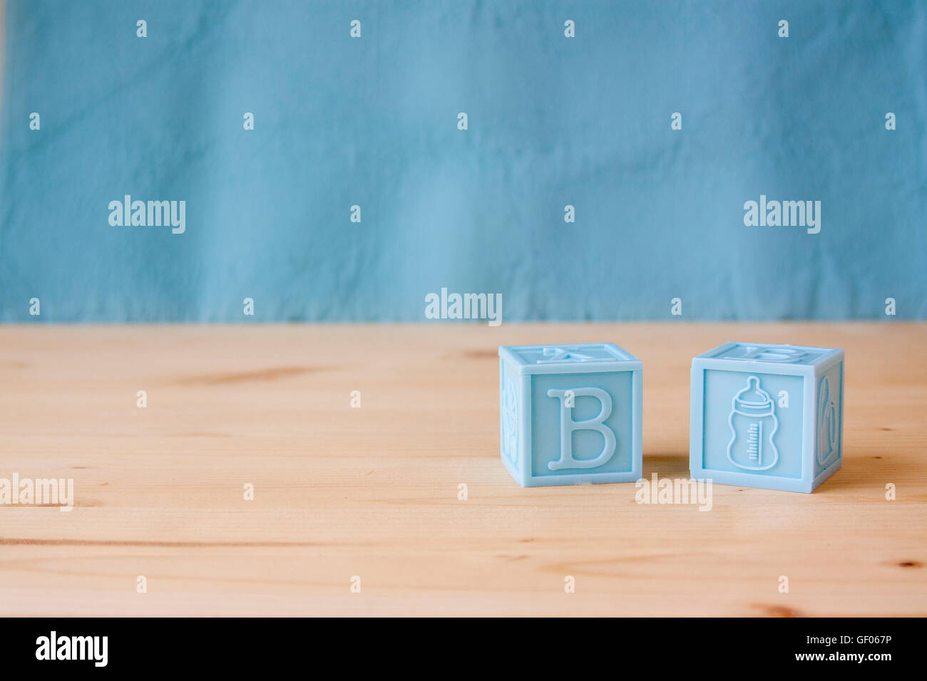 Blue Baby Blocks on a Blue and Wooden Background Stock Photo - Alamy