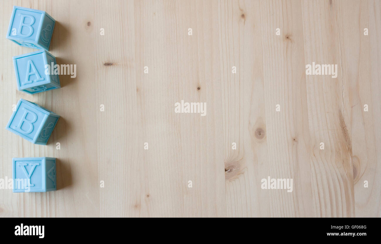 Blue Baby Blocks on a Wooden Background Stock Photo - Alamy
