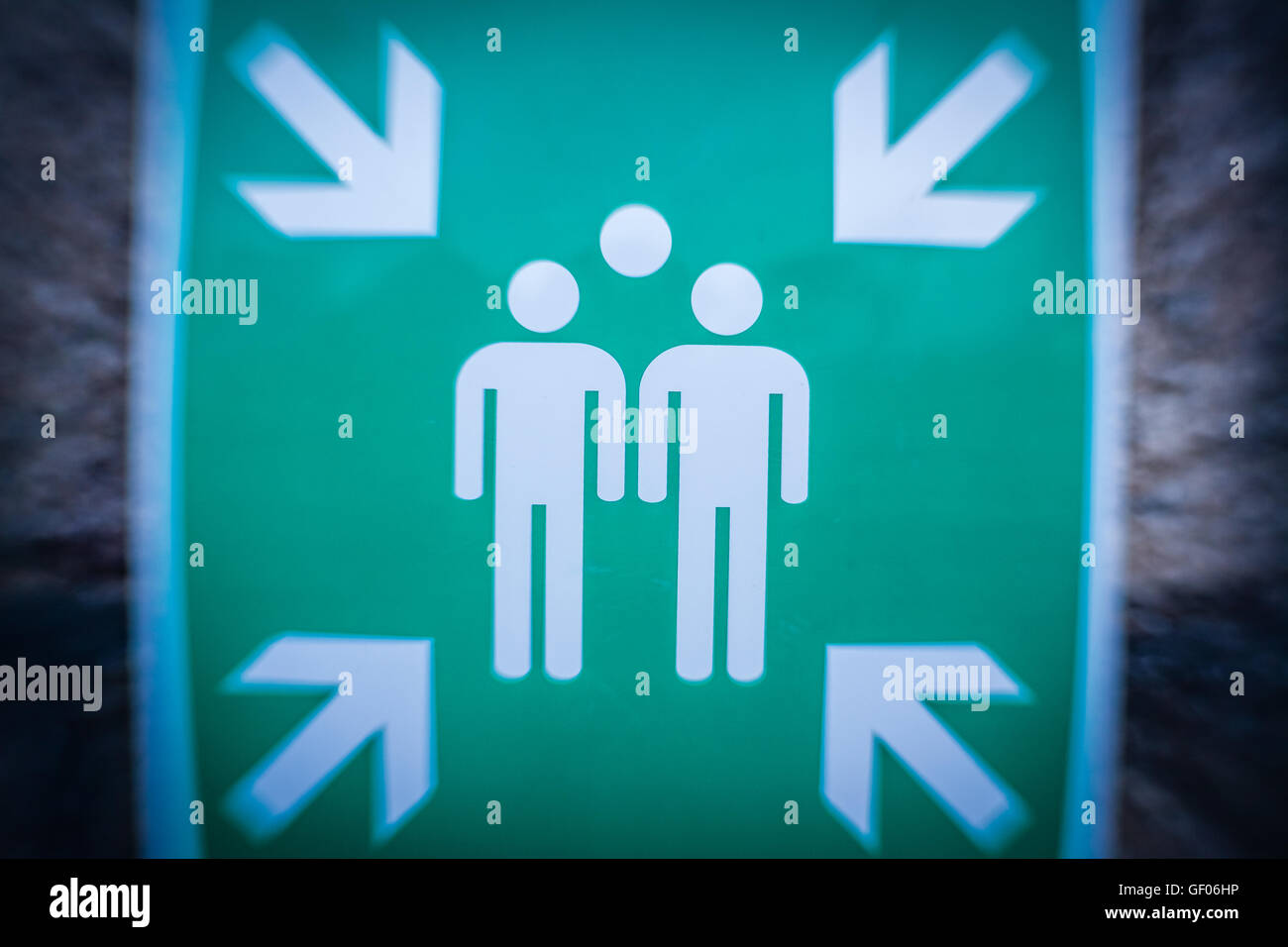 Green sign indicating the assembly point for people in case of fire ...