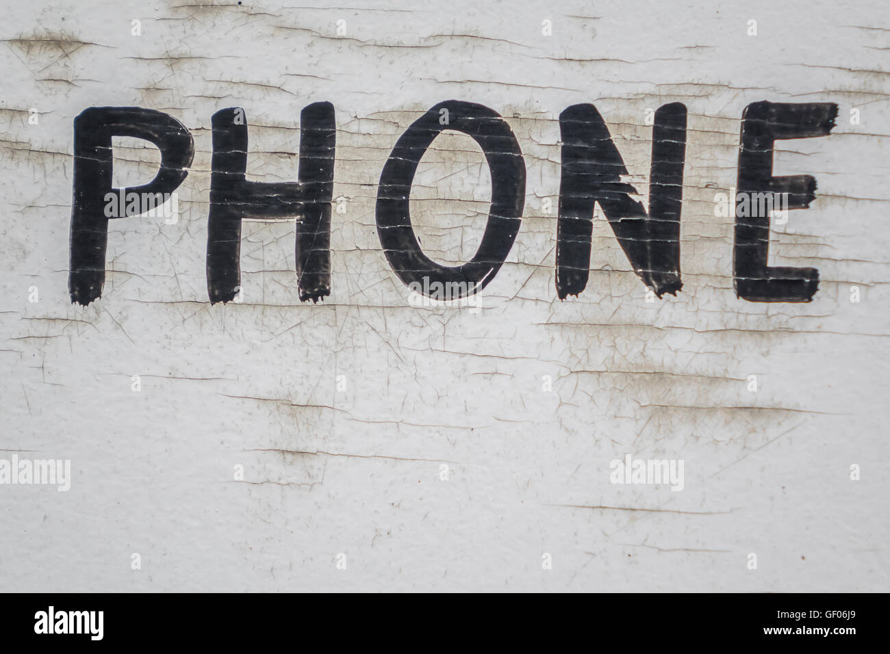 Letter spelling phone written on an old weathered wooden white wall ...