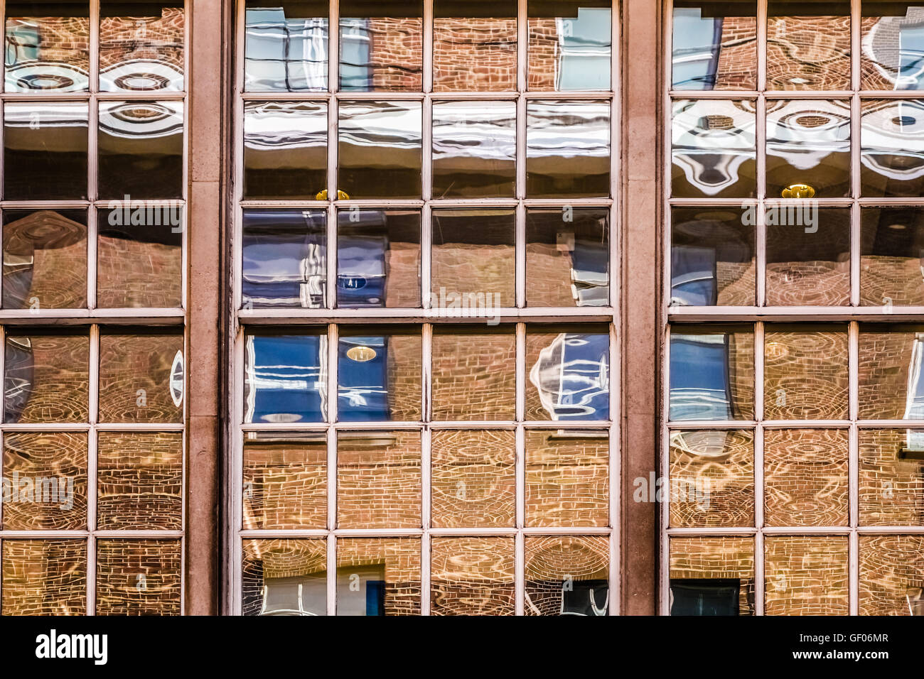 Distorted reflection in the windows of an office building Stock Photo ...