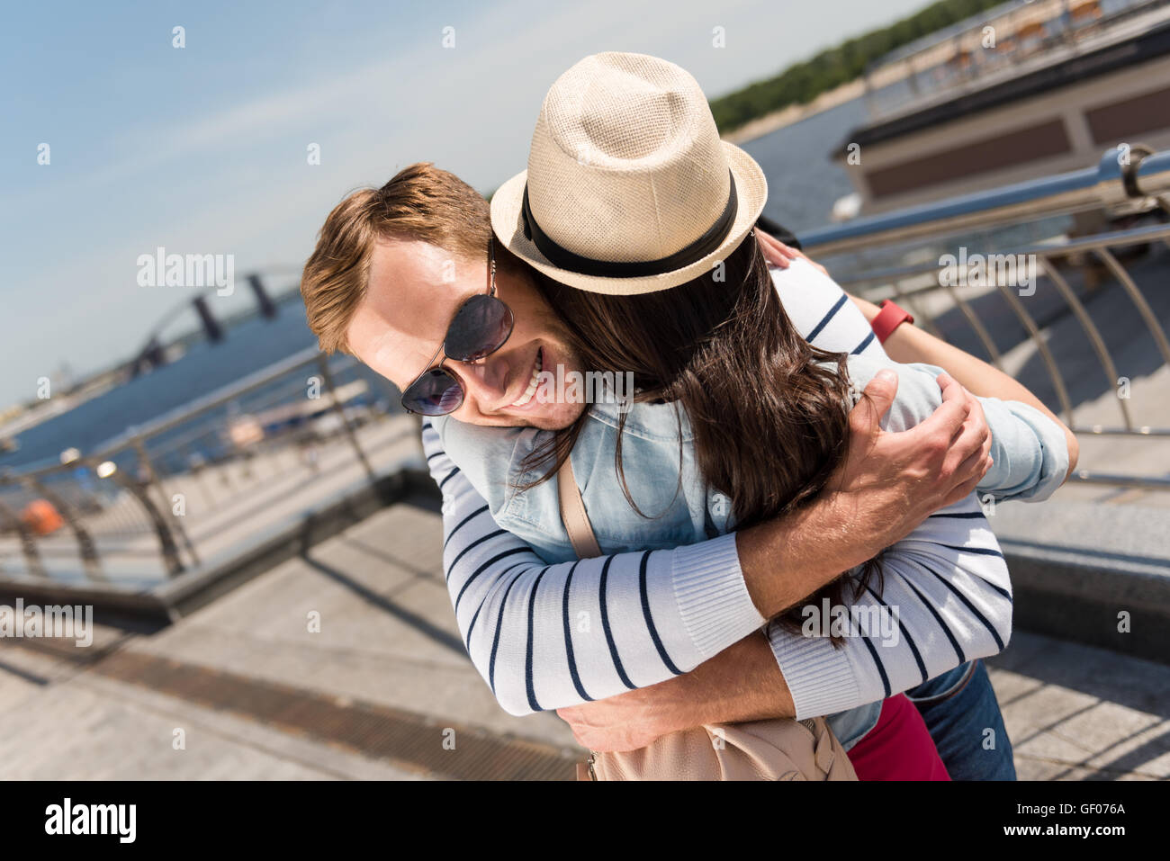 Positive couple embracing Stock Photo - Alamy